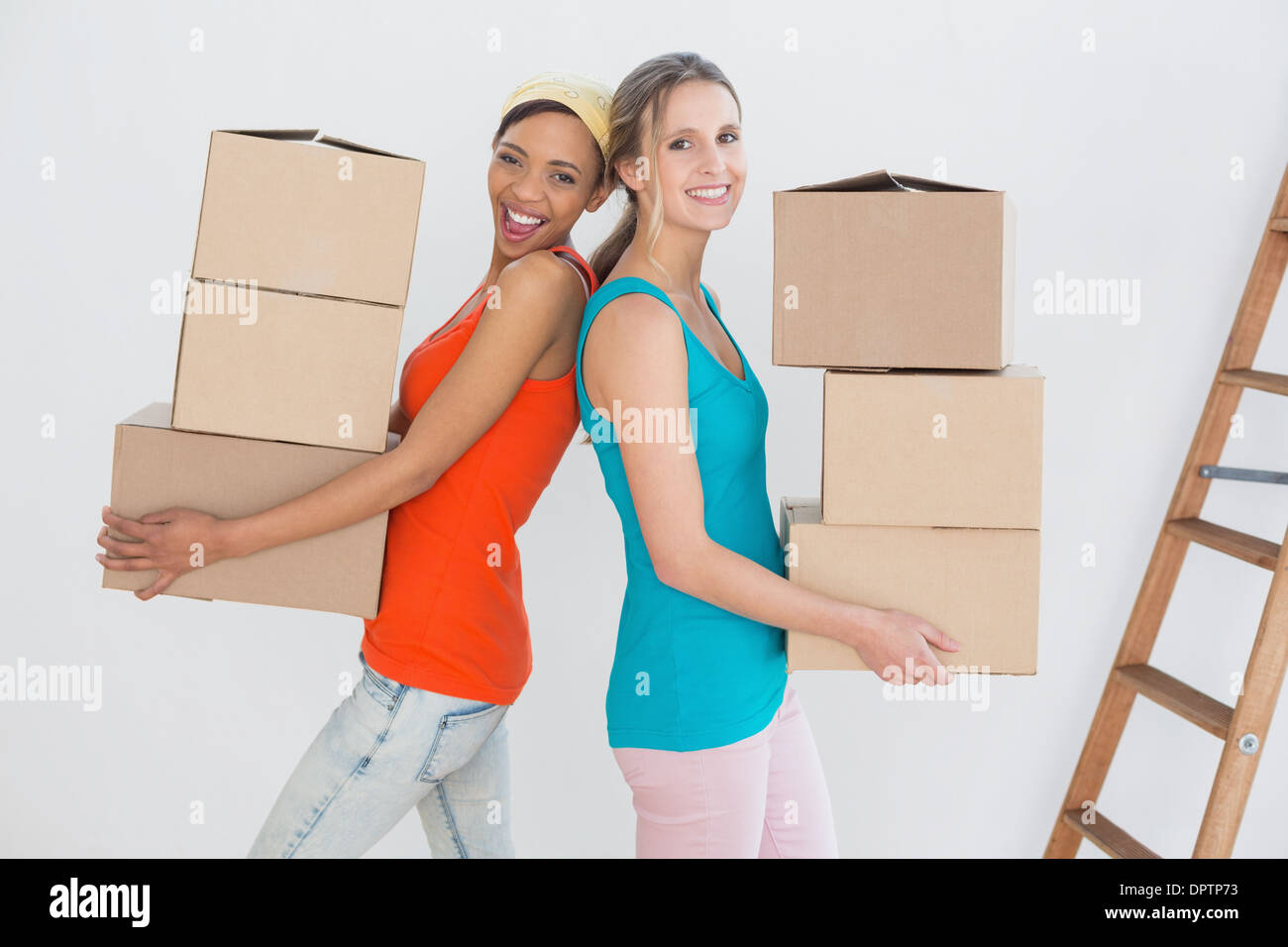 Female friends moving together in a new house Stock Photo - Alamy