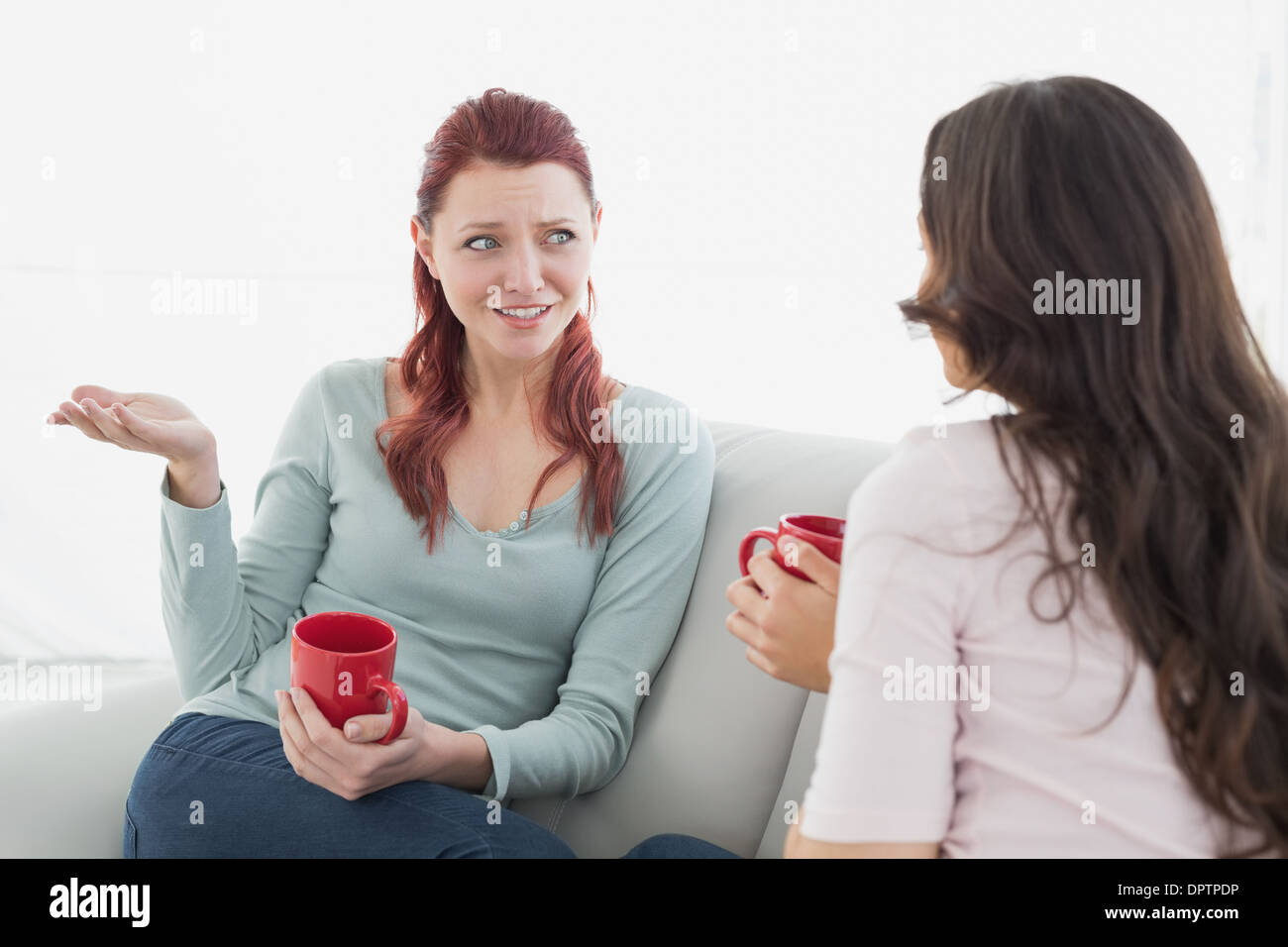 Female friends enjoying a chat over coffee at home Stock Photo - Alamy