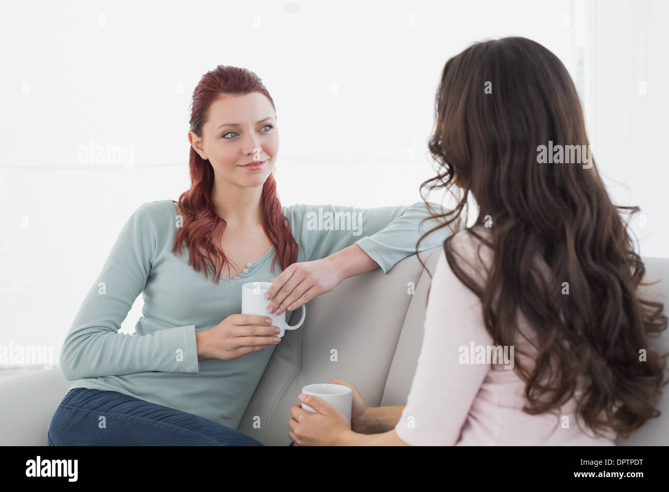 Female friends enjoying a chat over coffee at home Stock Photo - Alamy