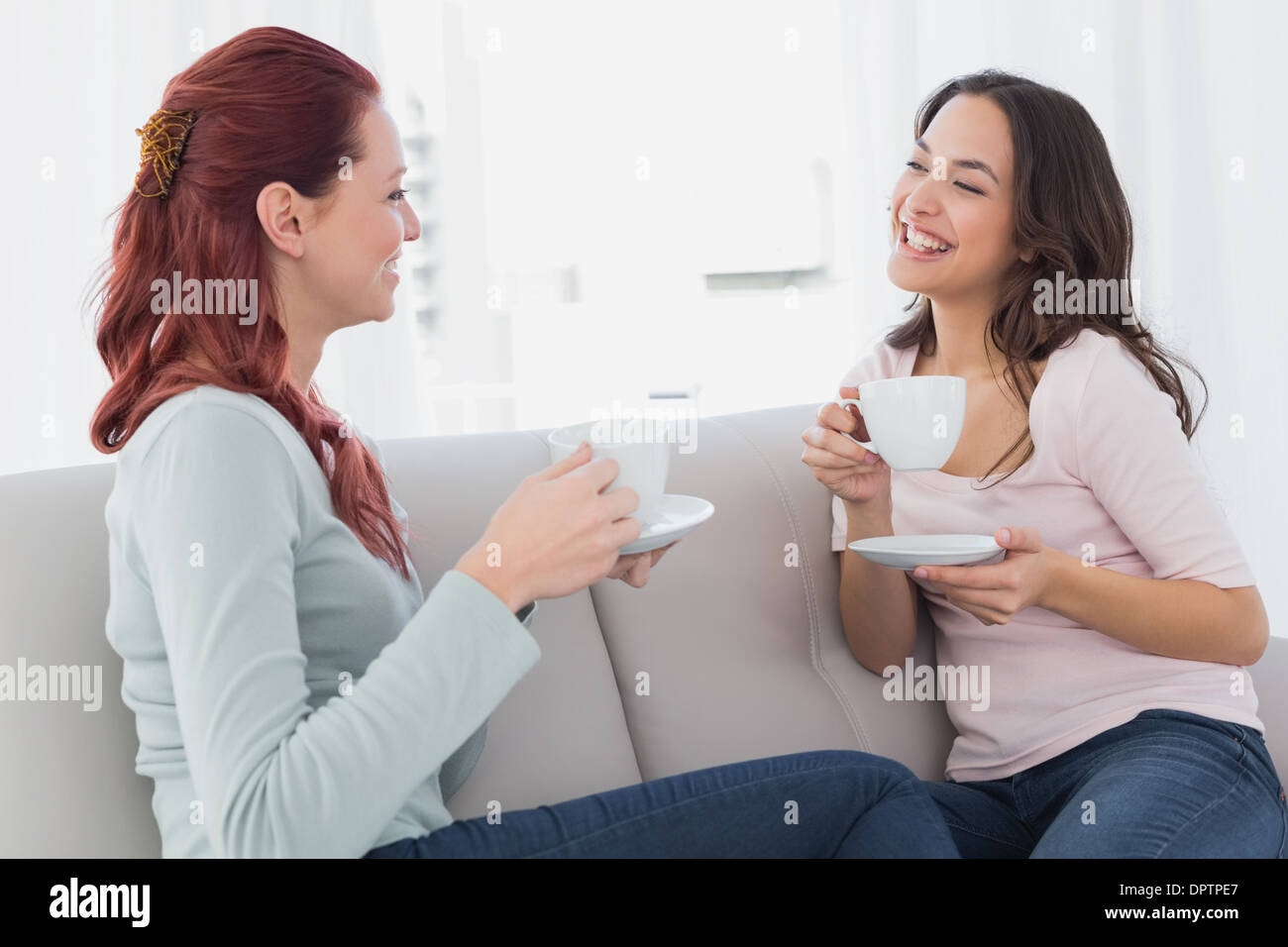 Female friends enjoying a chat over coffee at home Stock Photo - Alamy