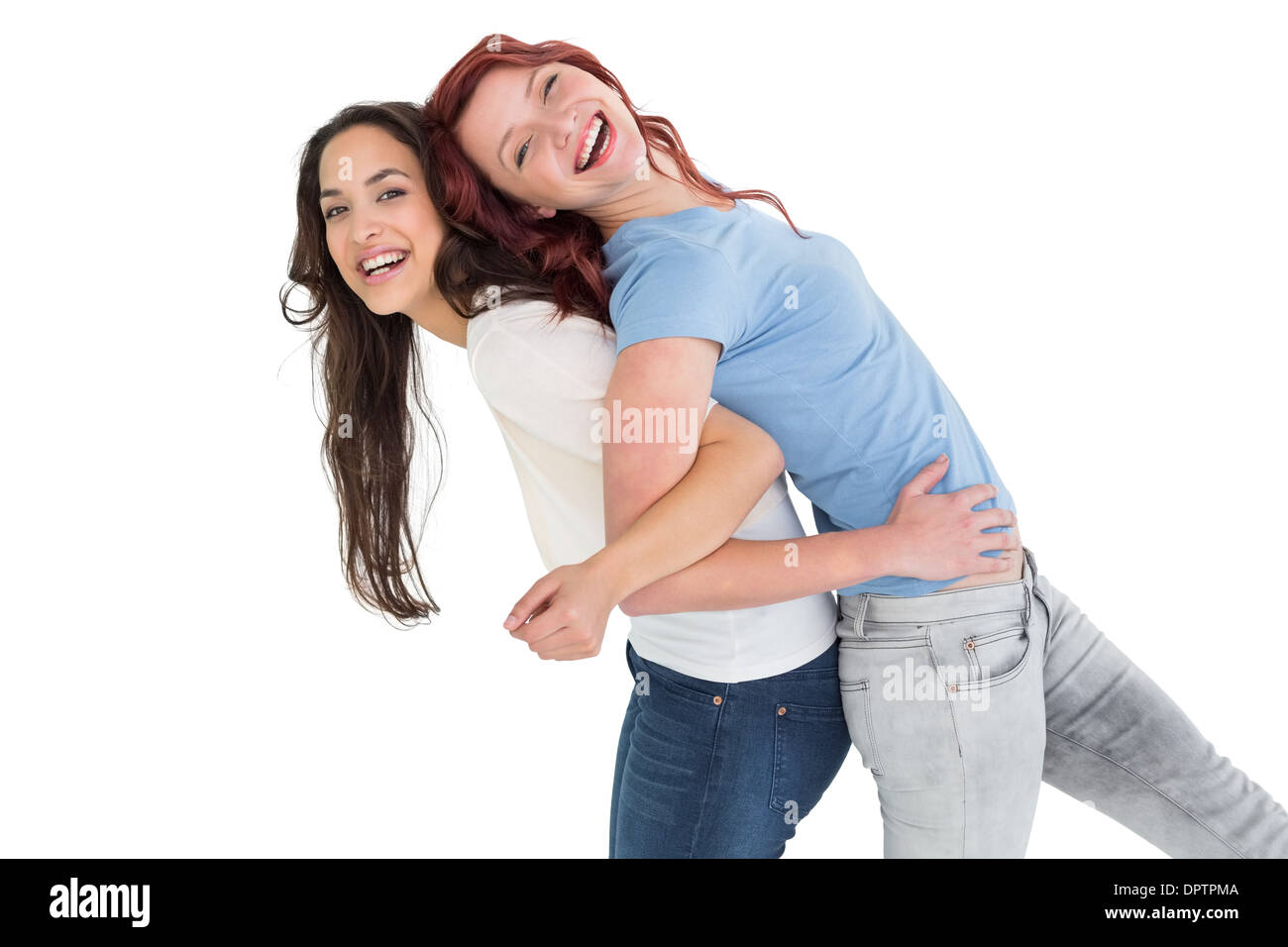Portrait of a young woman carrying female friend on back Stock Photo ...