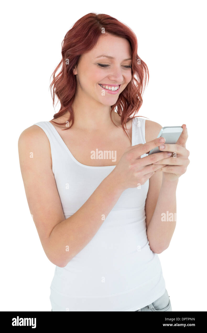 Smiling casual young woman text messaging Stock Photo - Alamy