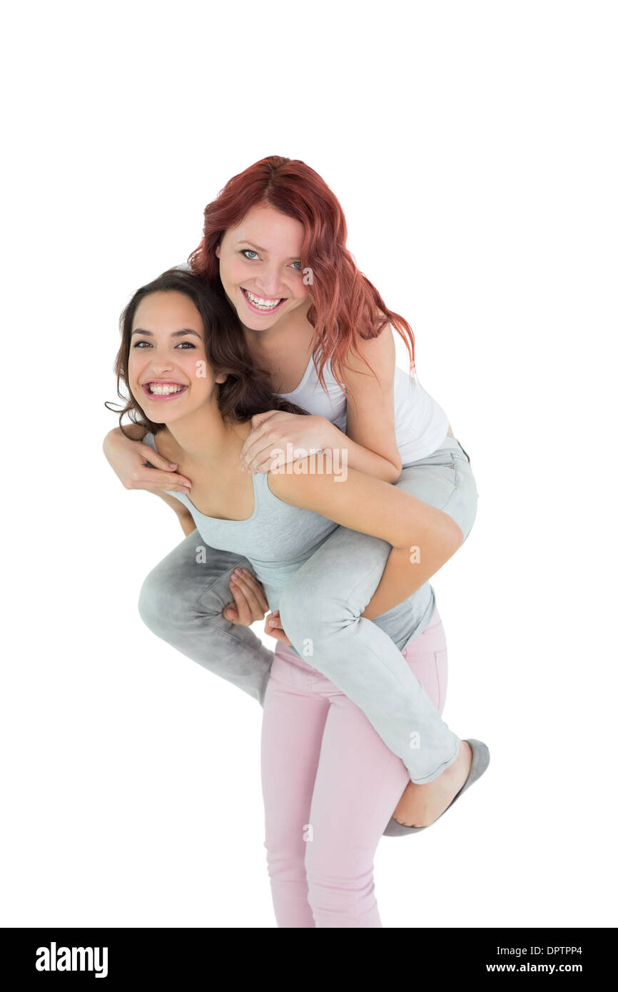 Happy young female piggybacking cheerful friend Stock Photo - Alamy