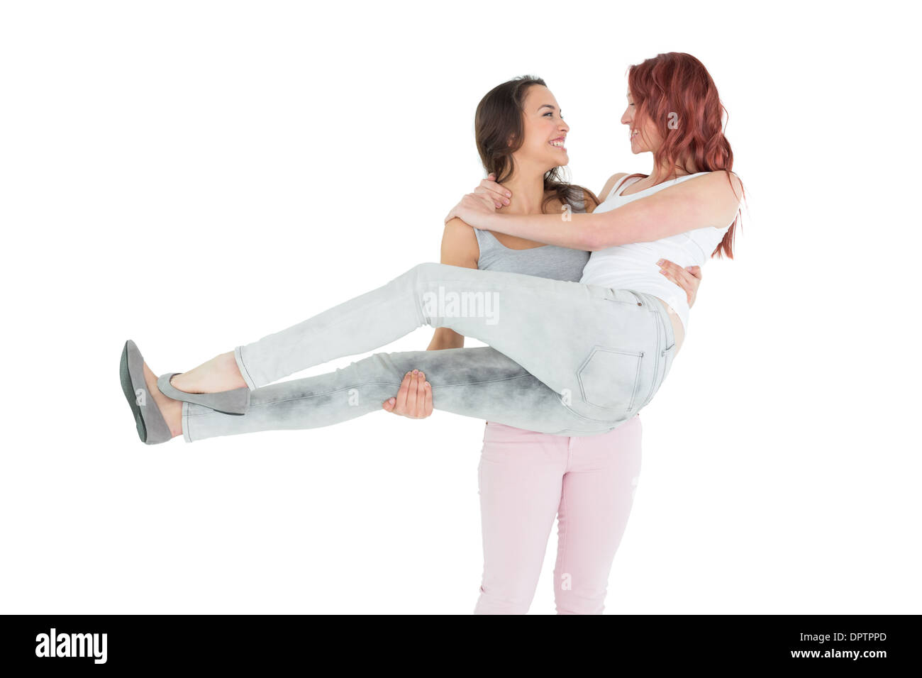 Cheerful young female carrying her happy friend Stock Photo - Alamy