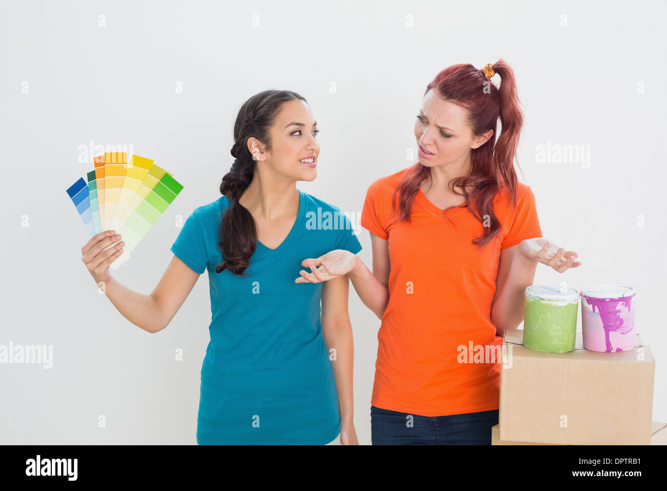 Confused friends choosing color for painting a room Stock Photo - Alamy