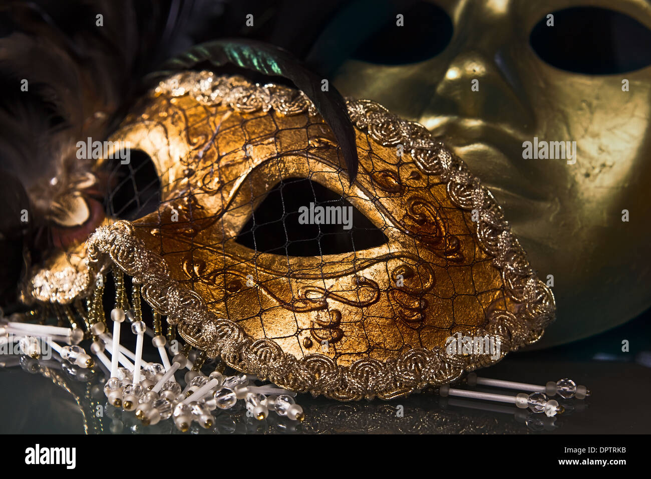 Old gold Venetian masks on a glass table Stock Photo - Alamy