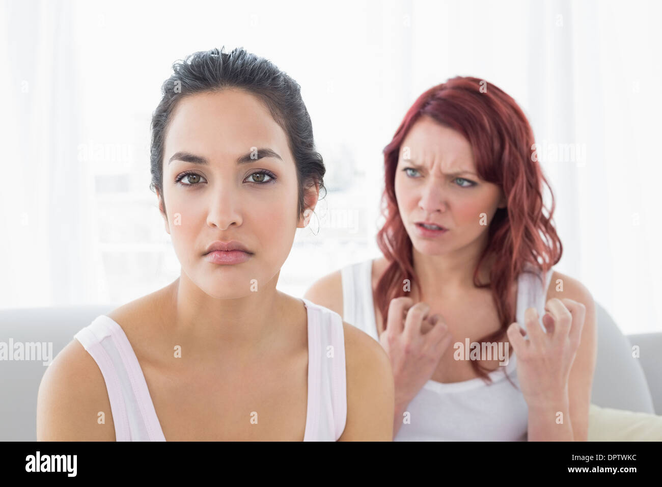 Angry friends having an argument in the living room Stock Photo - Alamy