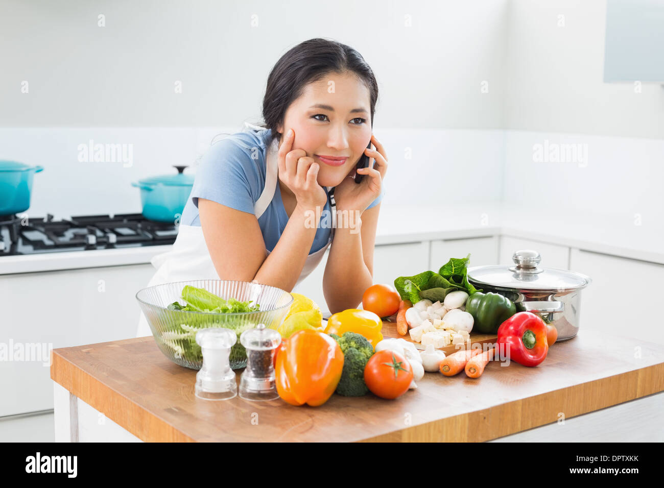 Cooking woman looking smartphone in hi-res stock photography and images ...