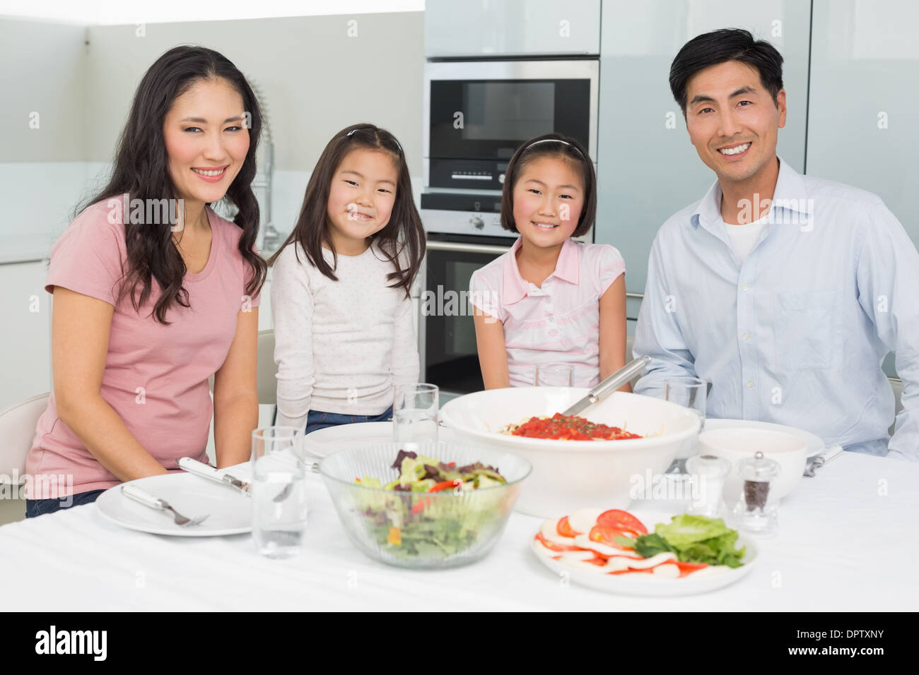 Family sitting in dining table hi-res stock photography and images - Alamy