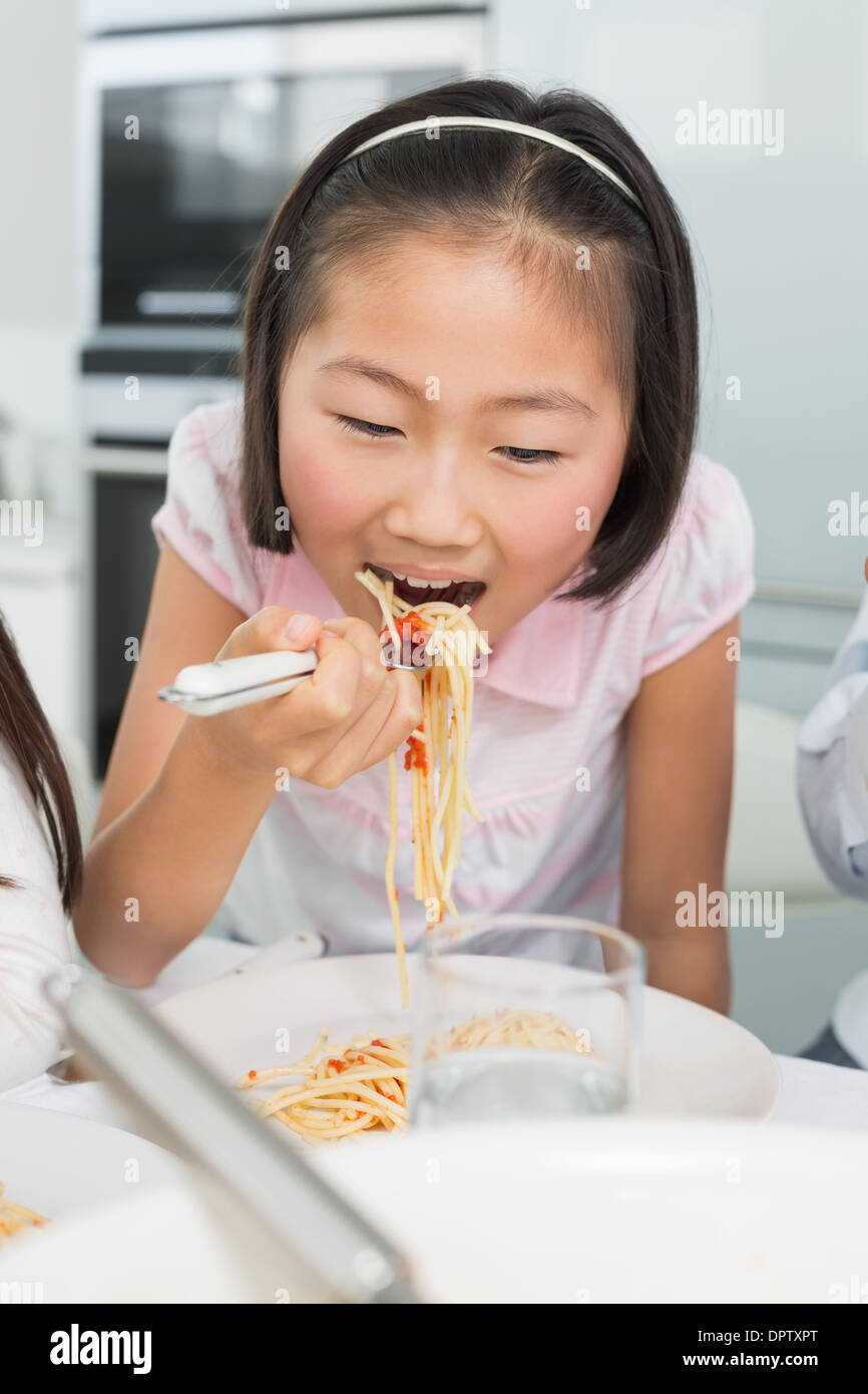 Close-up of a happy young kid enjoying spaghetti lunch Stock Photo - Alamy