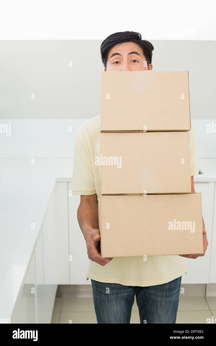 Young man carrying boxes in front of his face Stock Photo - Alamy