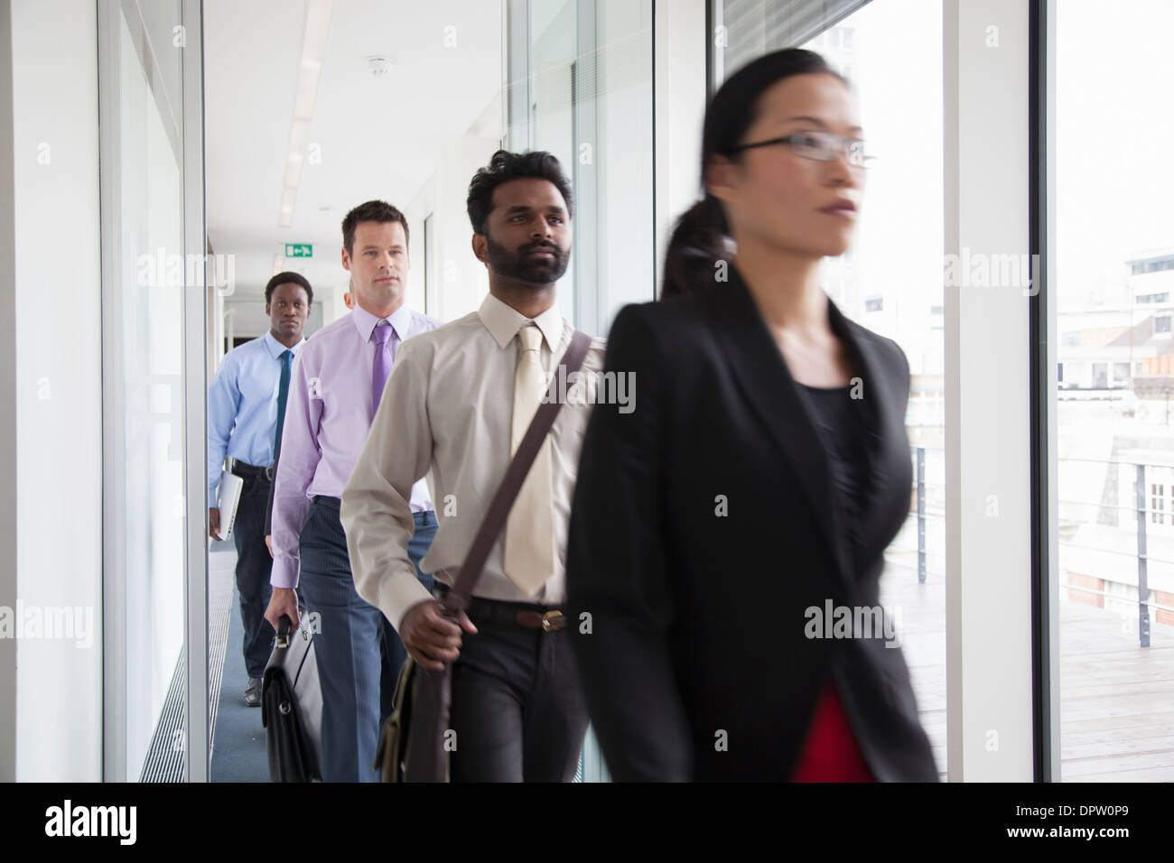 Office workers walking quickly down a corridor Stock Photo - Alamy