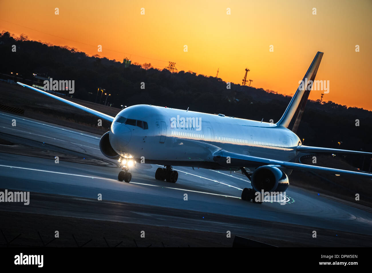 Delta Airlines jet in the colorful glow of sunset at Hartsfield-Jackson ...