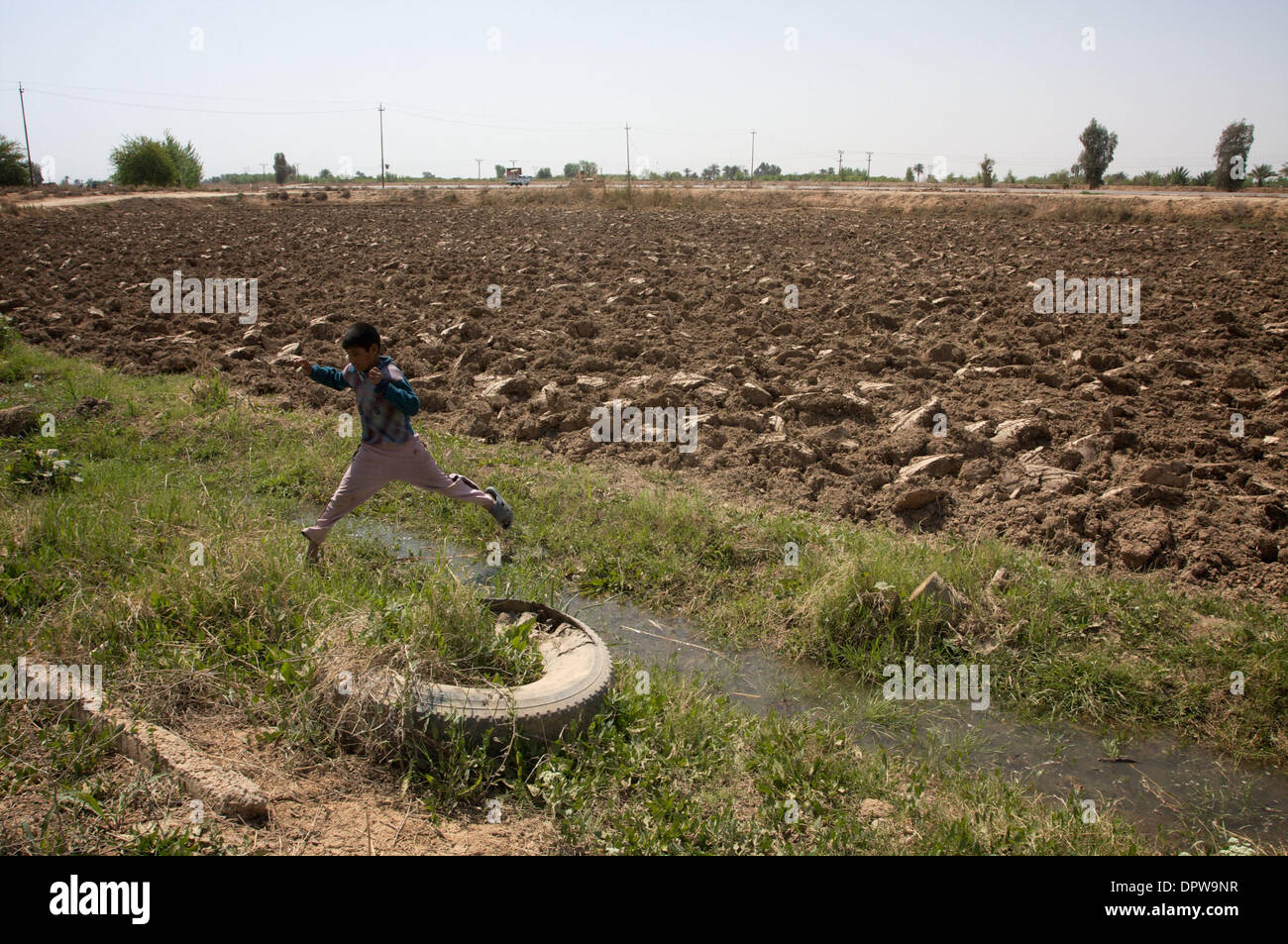 Mar 27, 2009 - Balad, Iraq - A boy jumps an irrigation canal near a ...