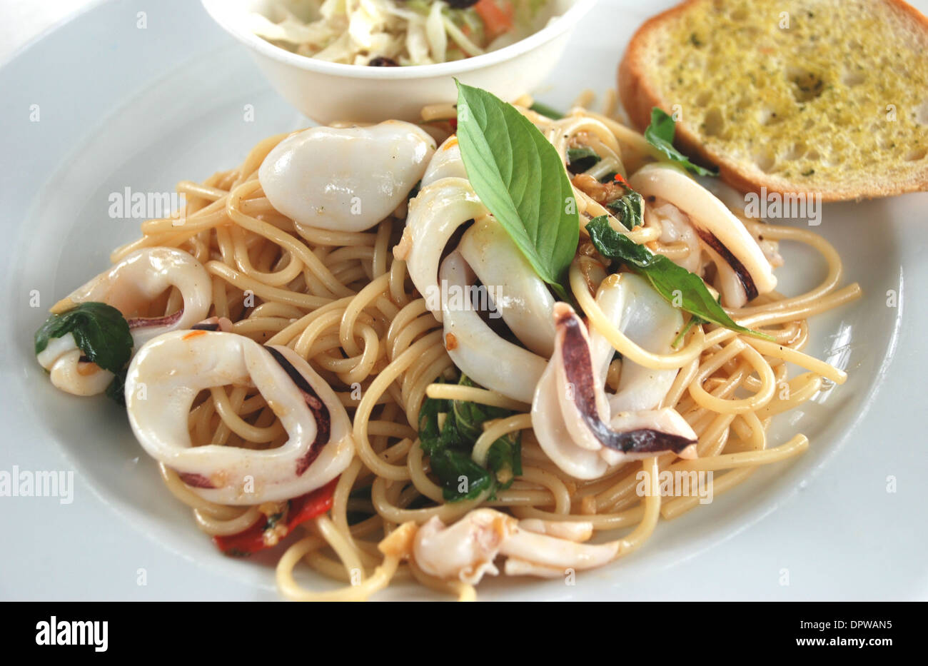 squids spaghetti basil sauce Thai fusion food Stock Photo - Alamy