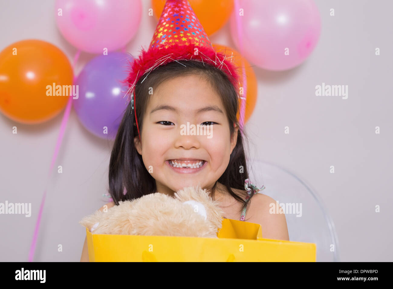 Little girl with gift at her birthday party Stock Photo - Alamy