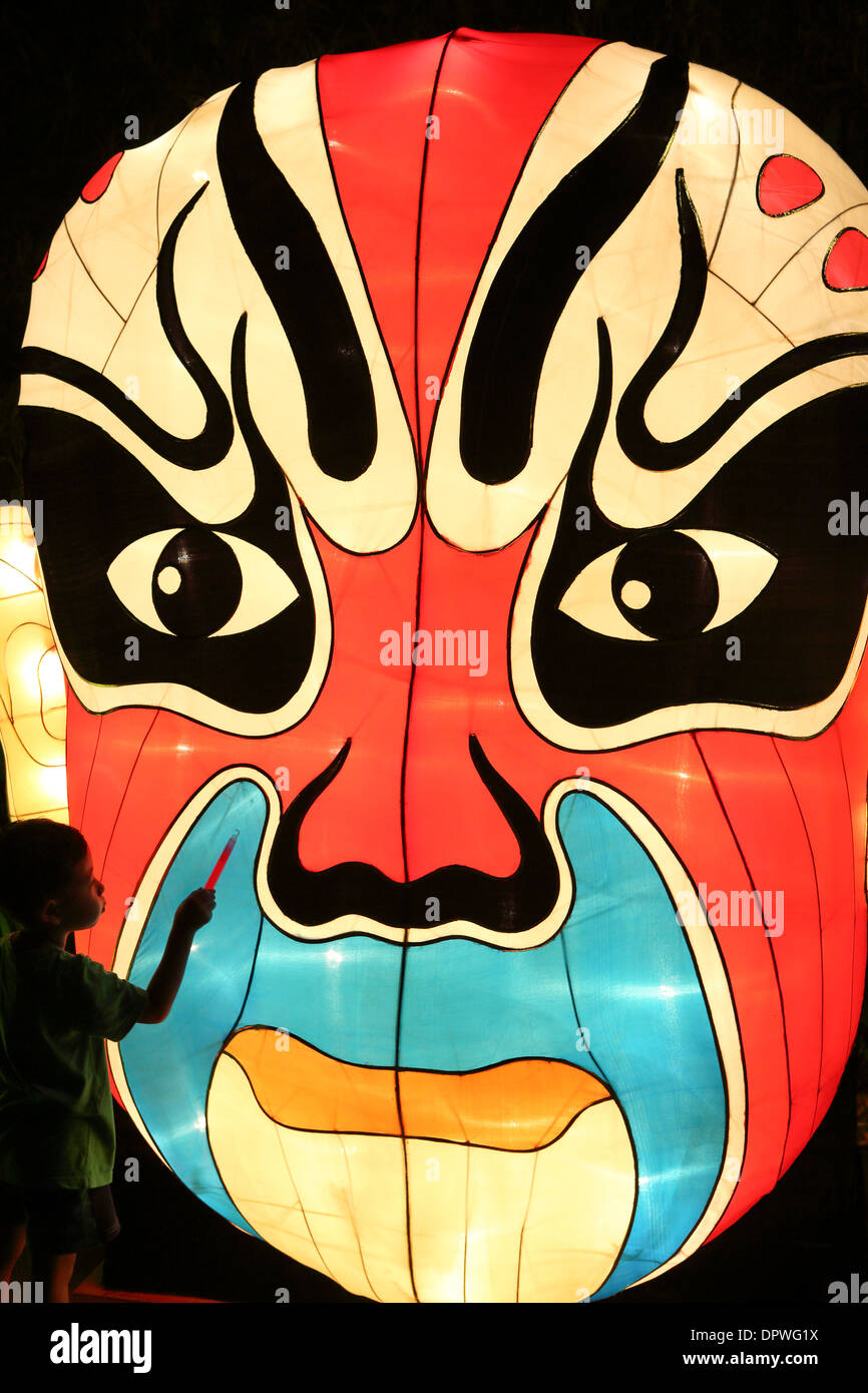 Boy looking at huge mask at lantern festival in Gardens by the Bay ...