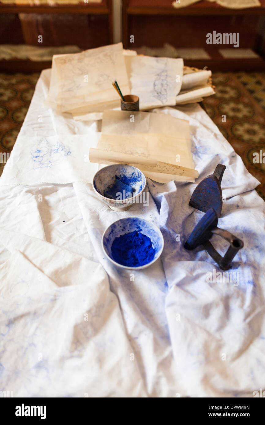 Blue dye powder and tracing paper and an old iron in a display showing ...