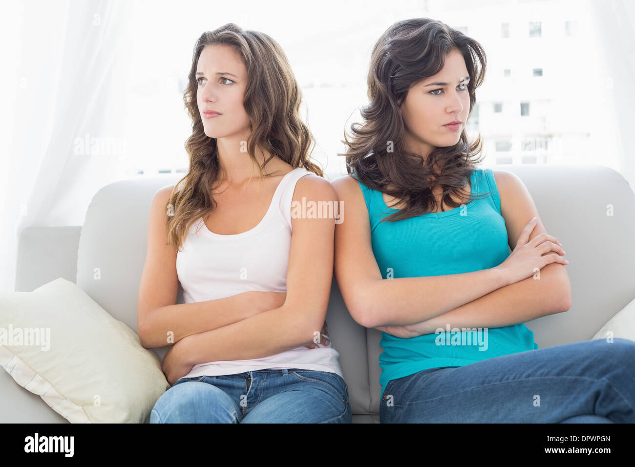Unhappy friends not talking after argument at home Stock Photo - Alamy