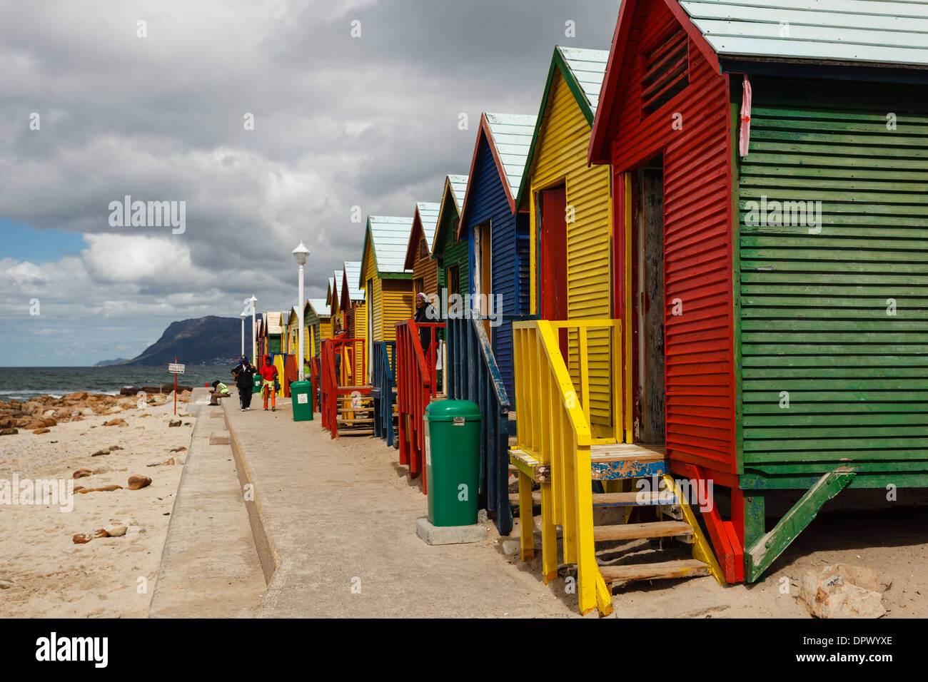 Long row of colorful victorian style beach huts line the waterfront in ... Long row of colorful victorian style beach huts line the waterfront in ...