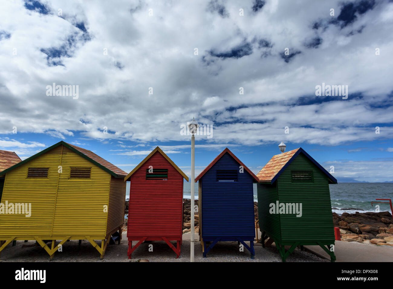 Back of four colorful victorian style beach huts in Muizenberg beach ... Back of four colorful victorian style beach huts in Muizenberg beach ...