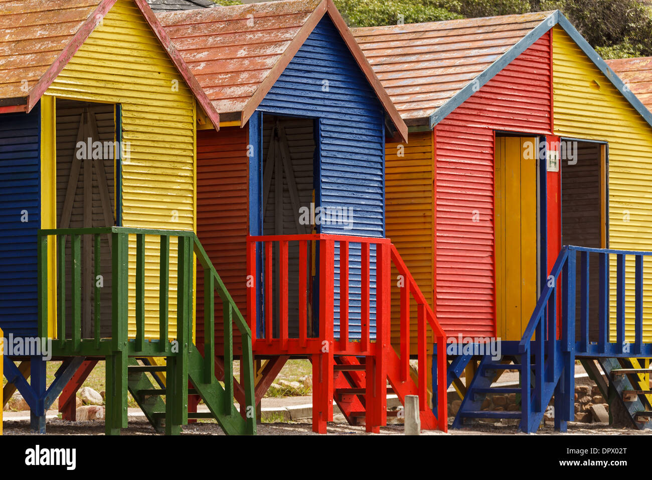 Three colorful victorian style beach huts line beach in Muizenberg ... Three colorful victorian style beach huts line beach in Muizenberg ...