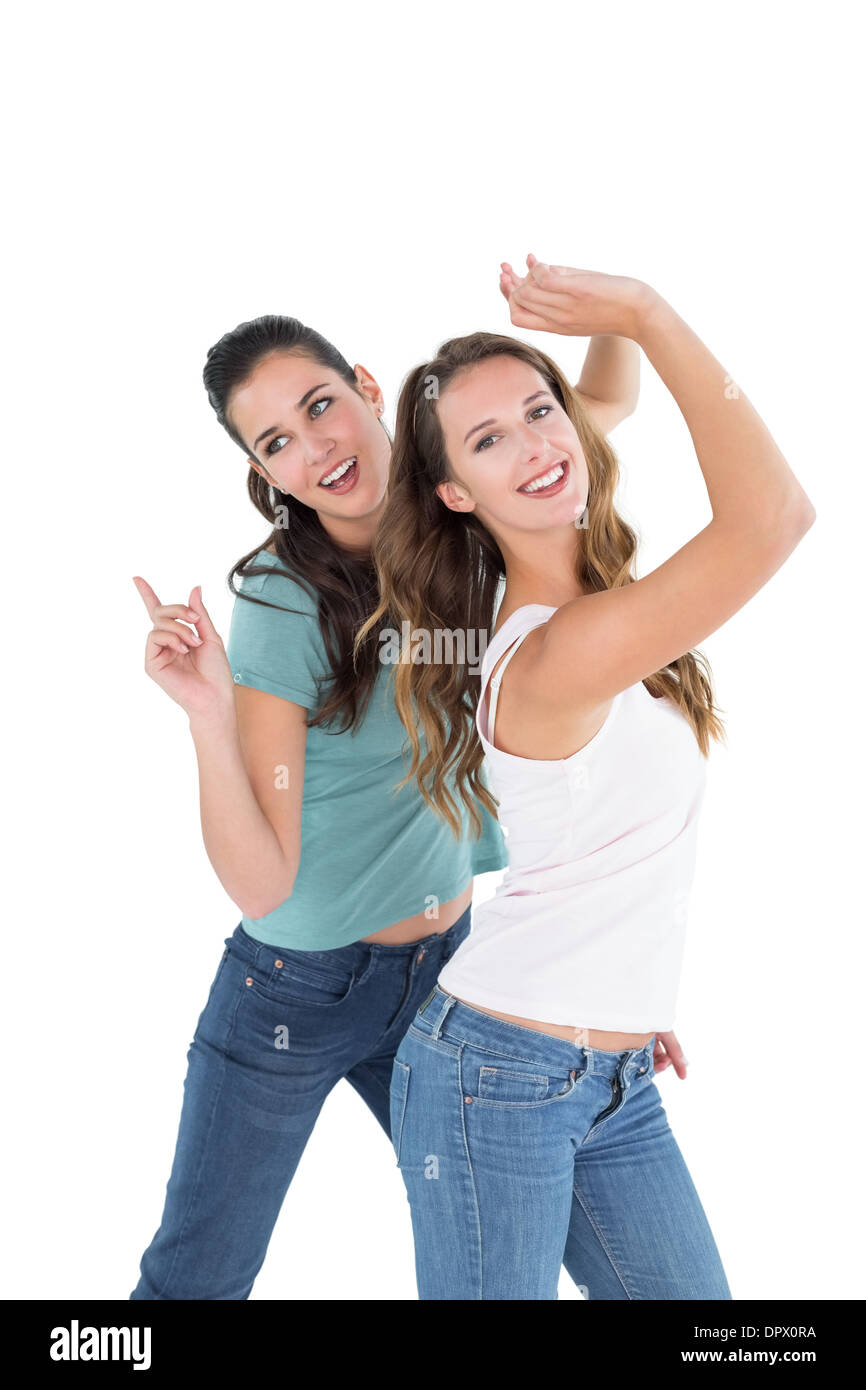 Two cheerful young female friends dancing Stock Photo - Alamy