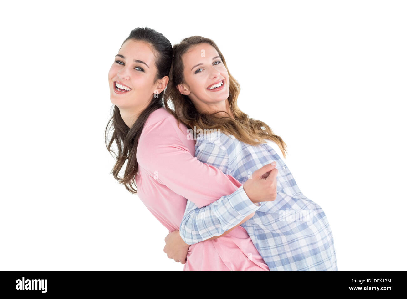 Young woman carrying female friend on back Stock Photo - Alamy