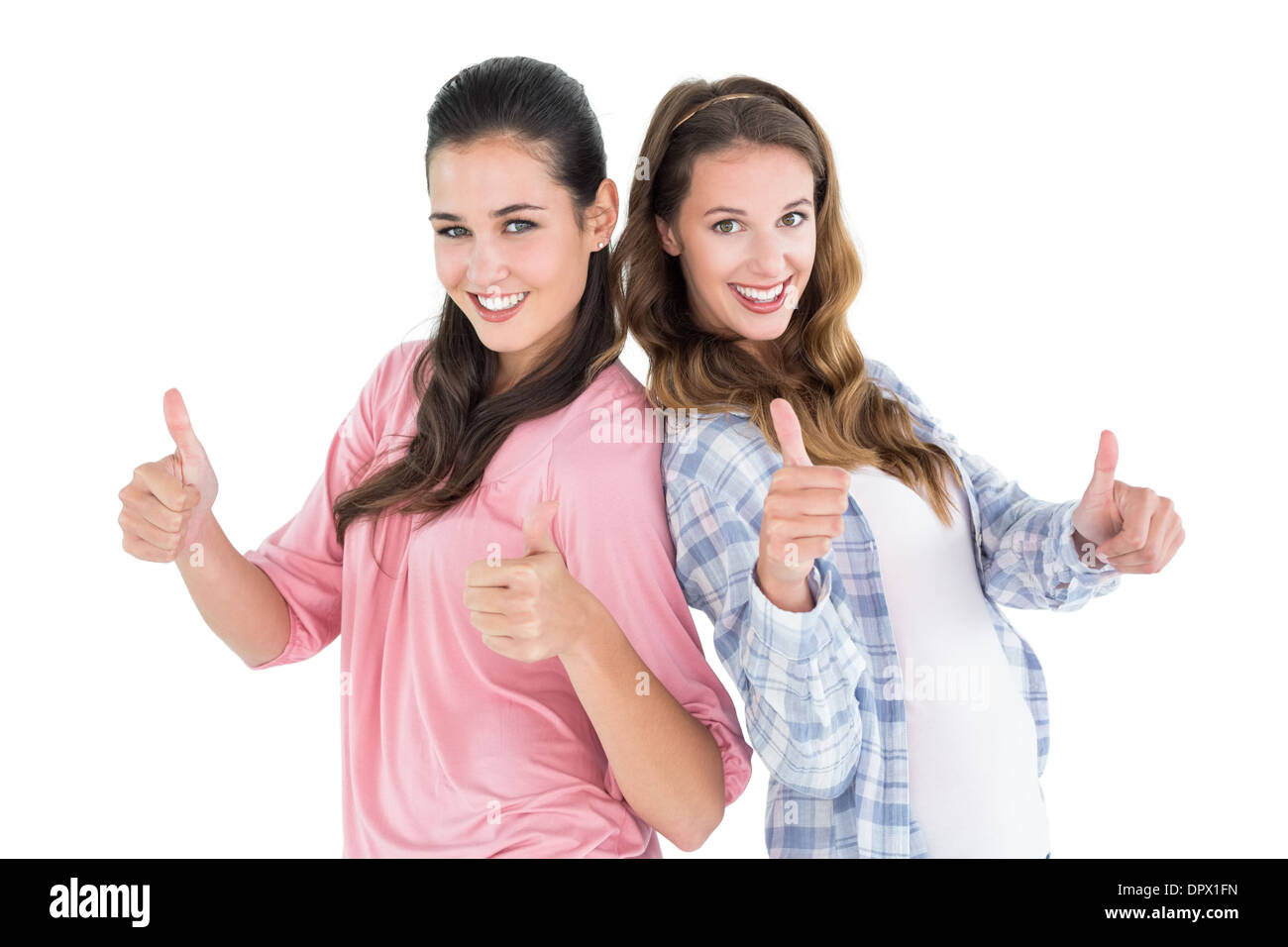 Portrait of two young female friends gesturing thumbs up Stock Photo ...