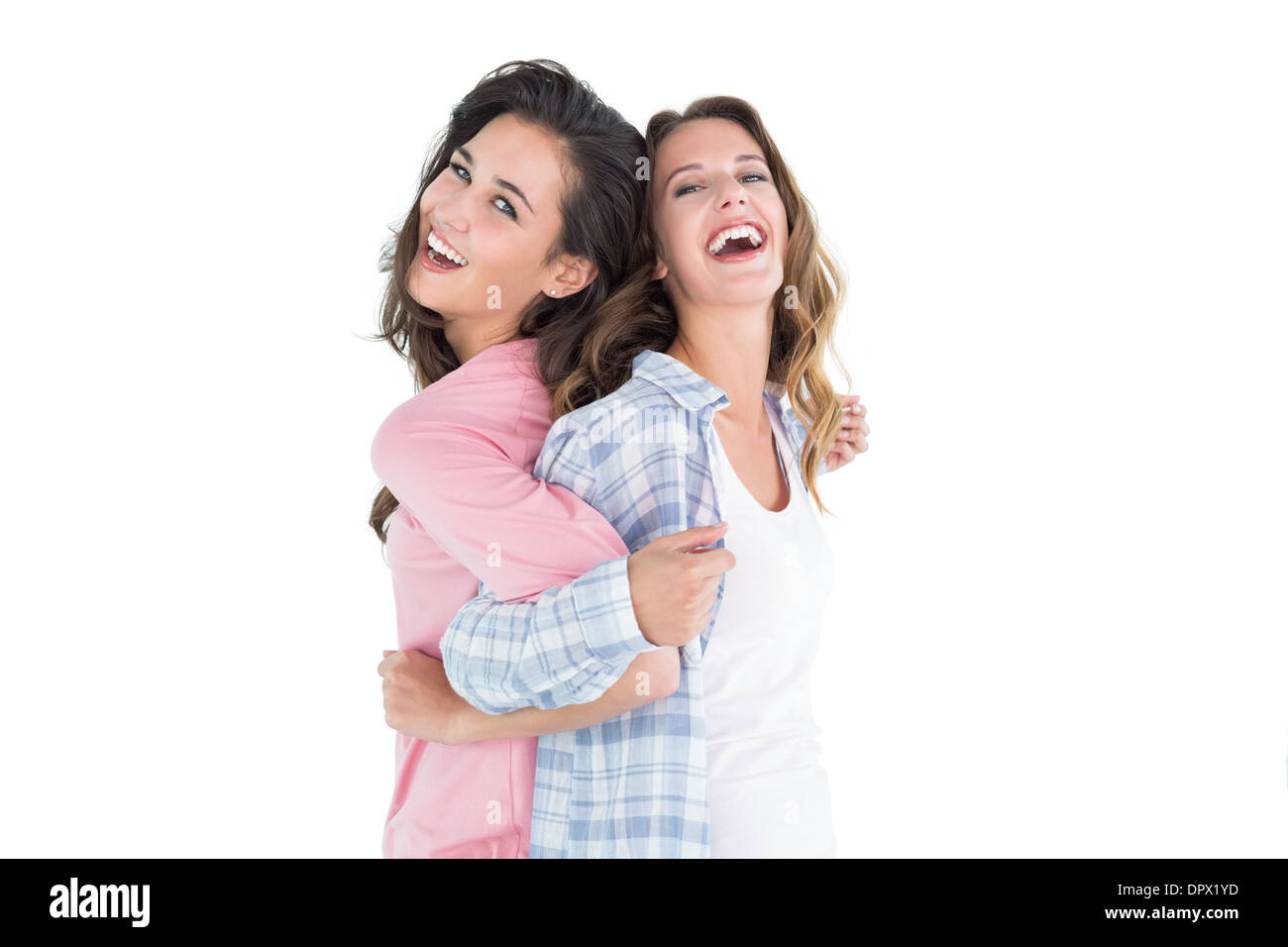Cheerful young women standing back to back Stock Photo - Alamy