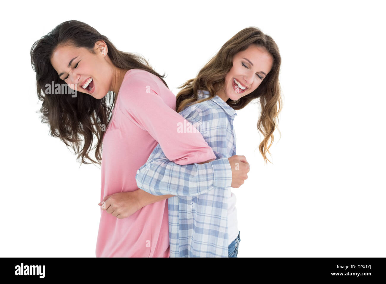 Women standing back to back with interlocked hands Stock Photo - Alamy