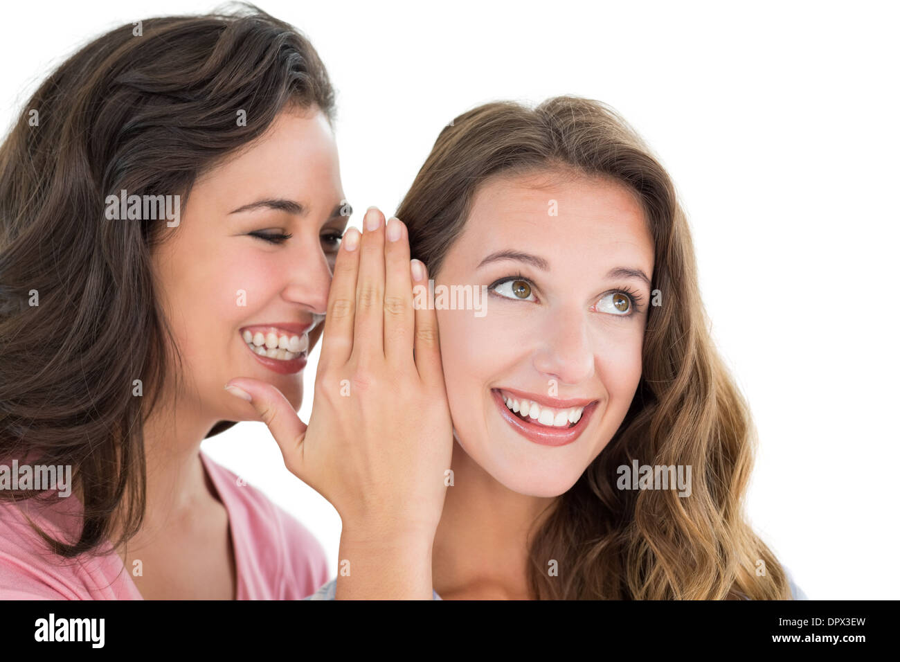 Two cheerful young female friends gossiping Stock Photo - Alamy