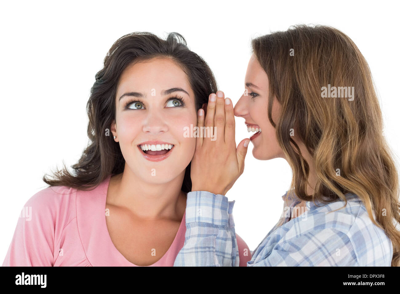 Two cheerful young female friends gossiping Stock Photo - Alamy