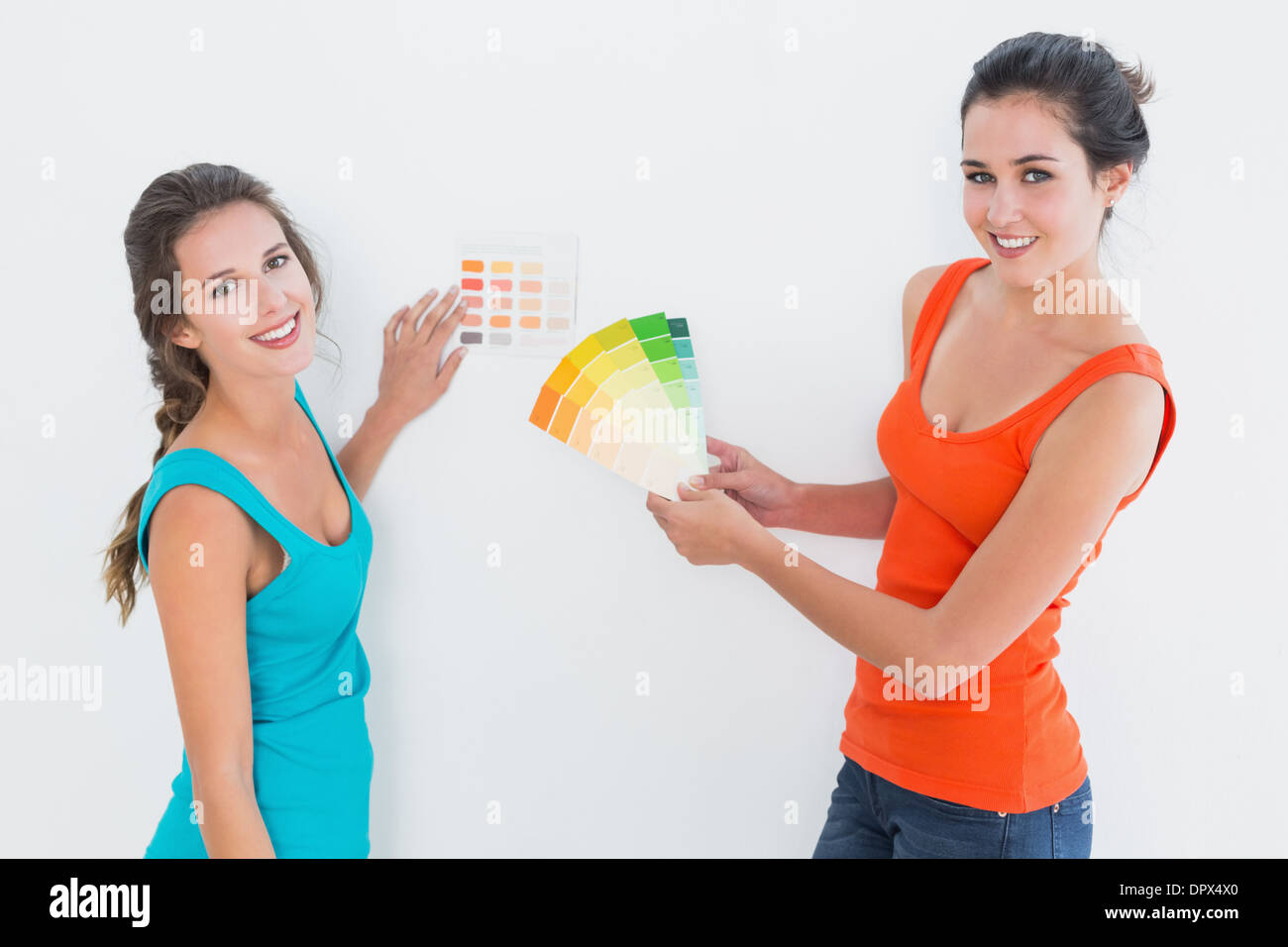 Female friends choosing color for painting a room Stock Photo - Alamy