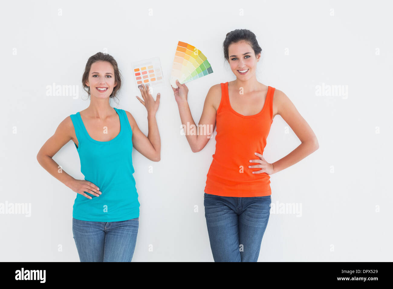 Female friends choosing color for painting a room Stock Photo - Alamy