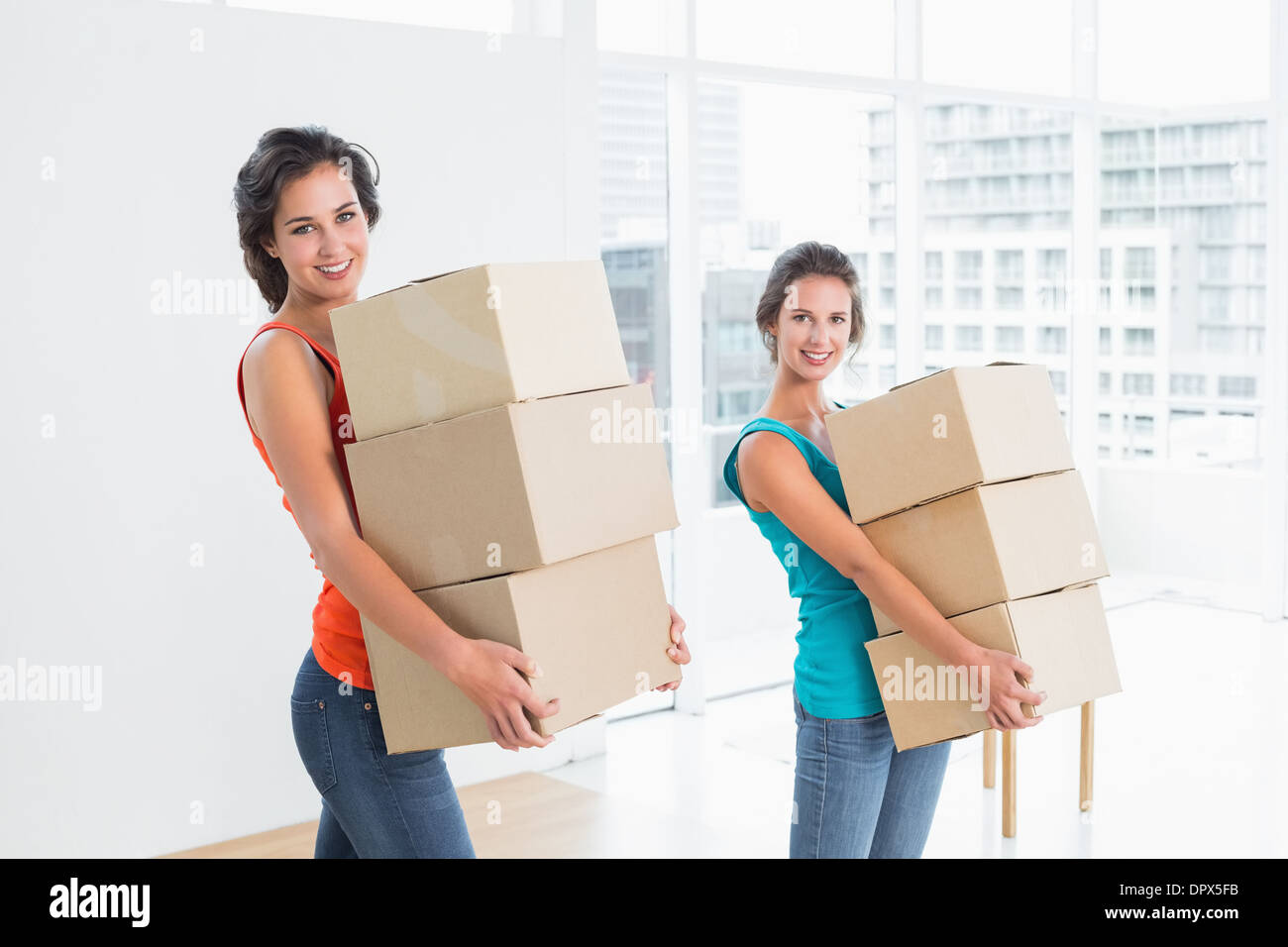 Friends carrying cardboard boxes hi-res stock photography and images ...