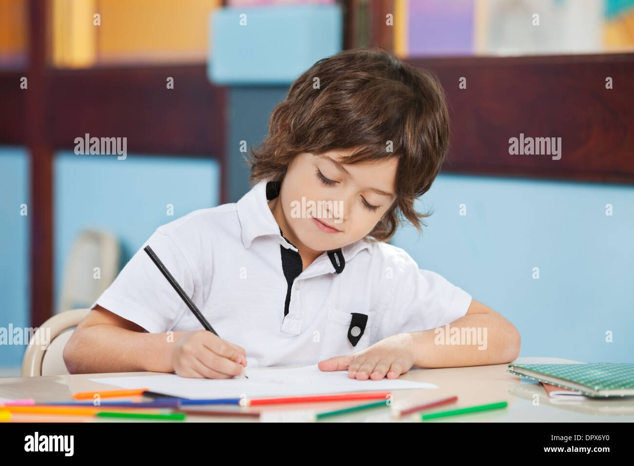 Boy With Sketch Pen Drawing In Kindergarten Stock Photo - Alamy
