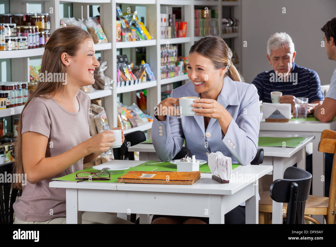 Happy Women Having Coffee At Supermarket Stock Photo - Alamy