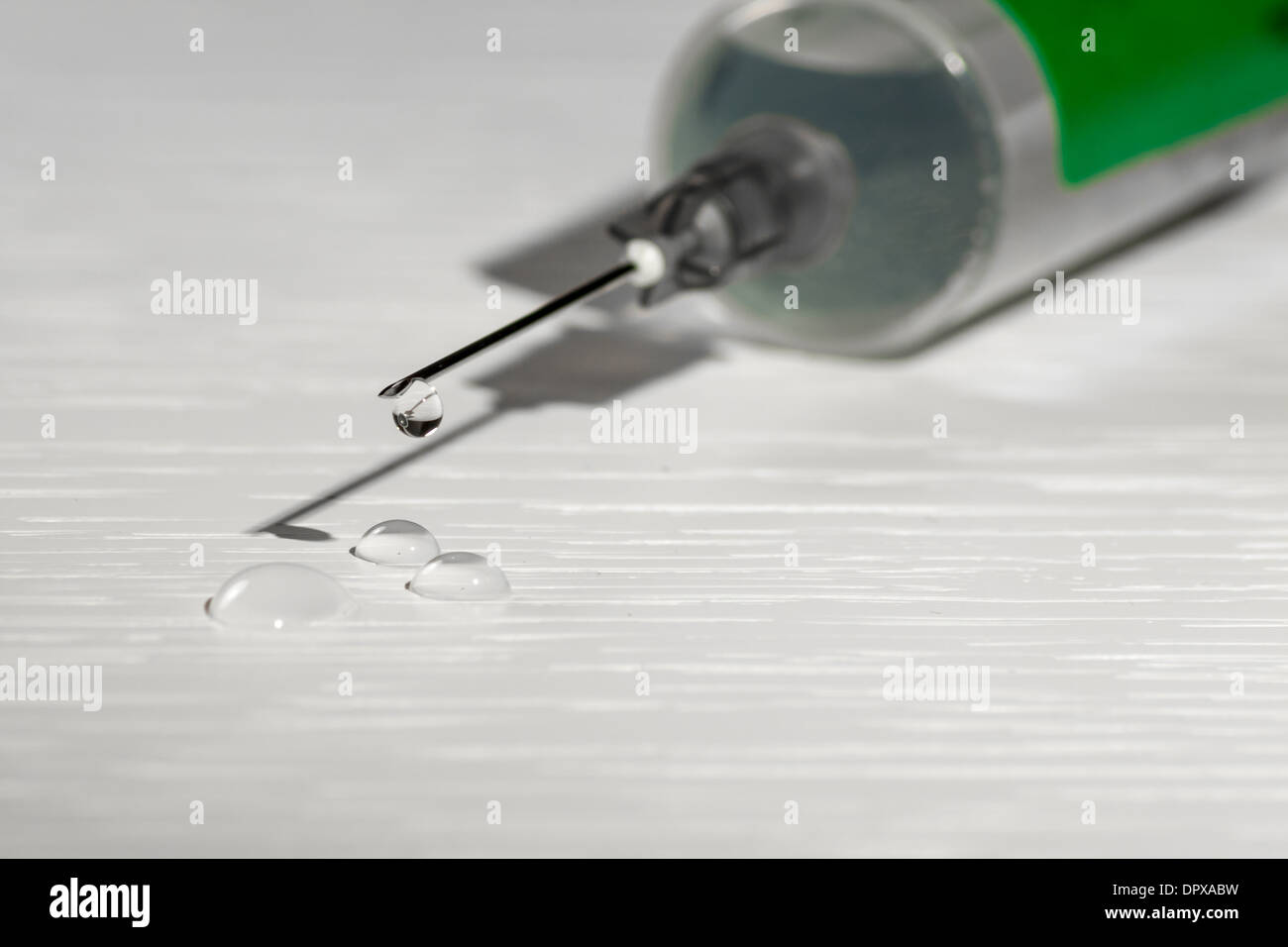 Syringe drug dropping from needle hi-res stock photography and images ...