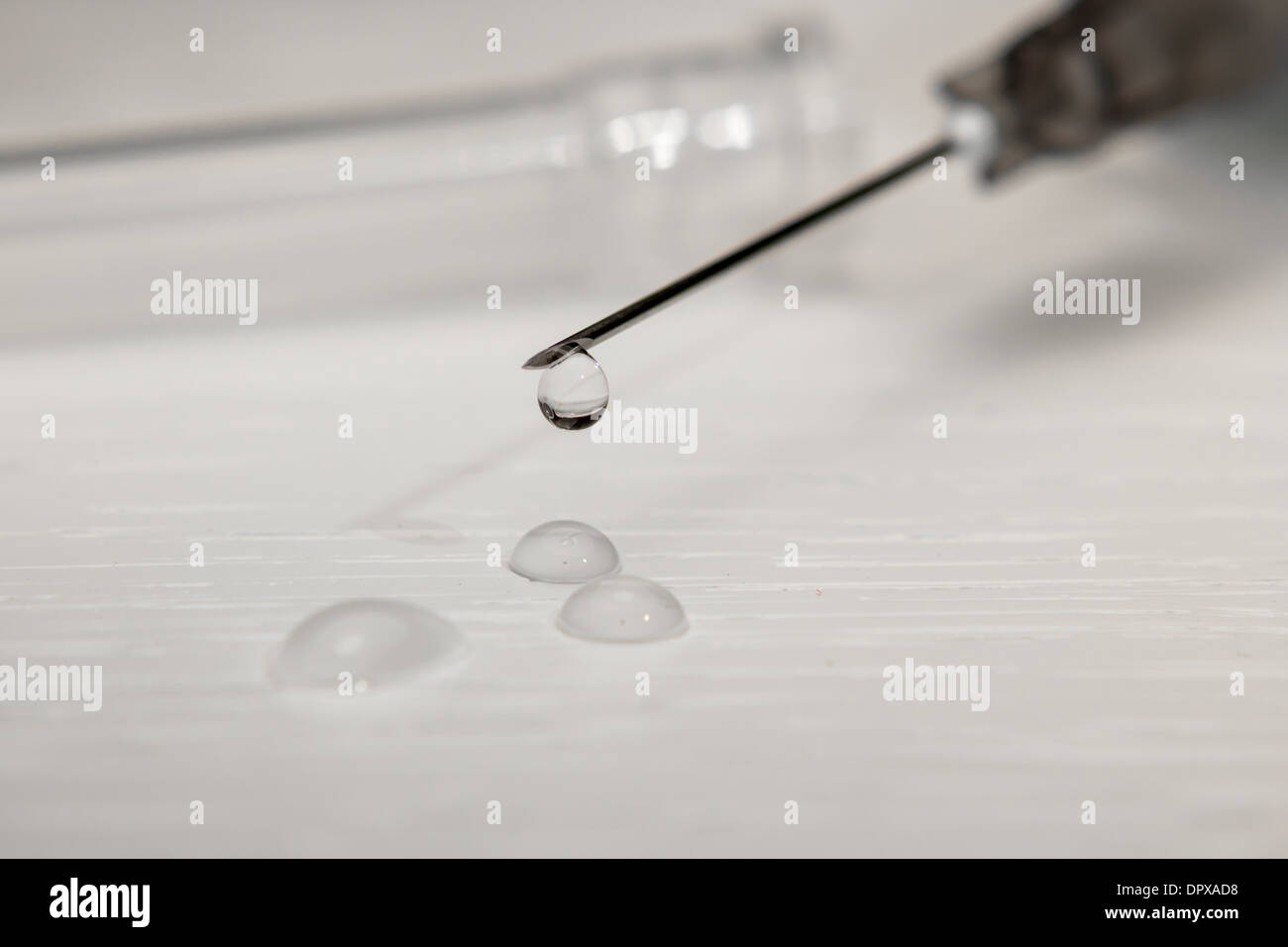 Syringe drug dropping from needle hi-res stock photography and images ...