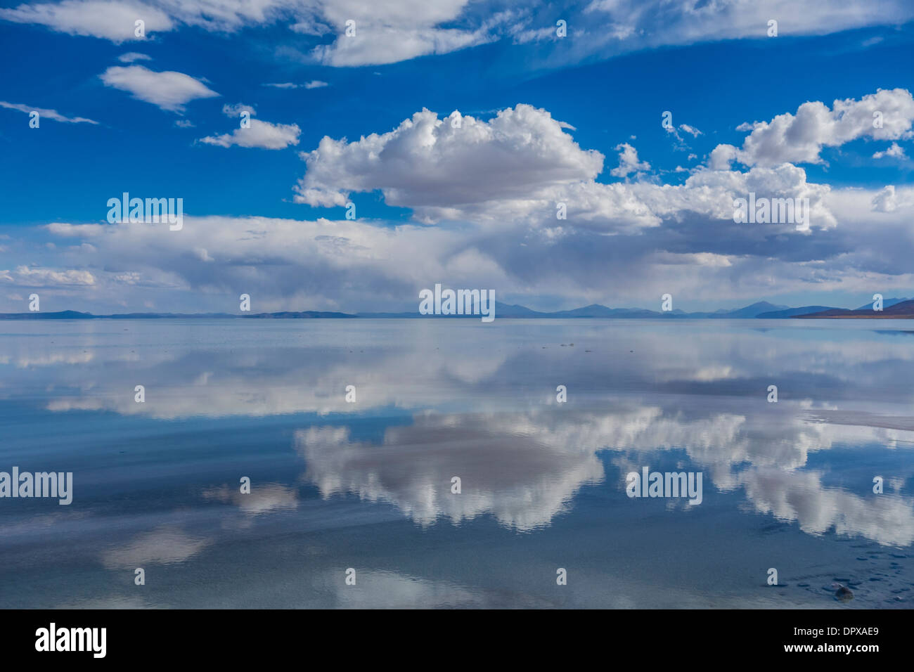 Cloud reflections creating symmetry in image in Salar de Uyuni, Bolivia ...