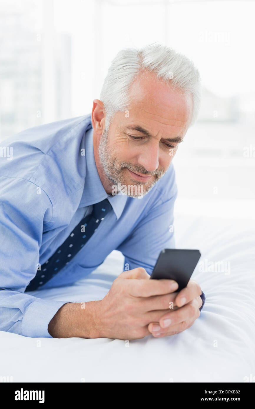 Relaxed man text using cellphone hi-res stock photography and images ...
