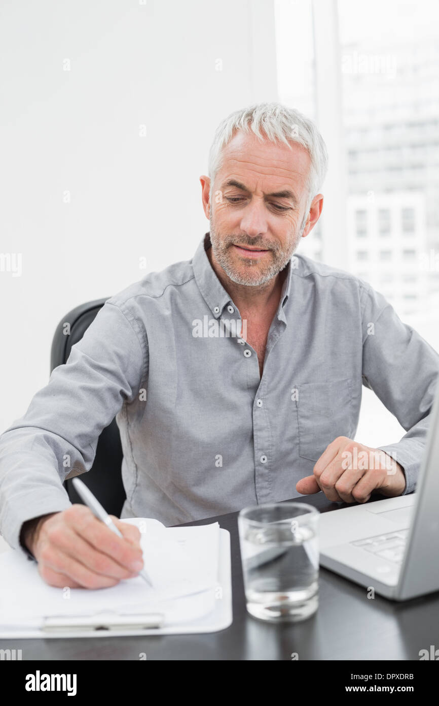 Businessman using laptop writing notes hi-res stock photography and ...