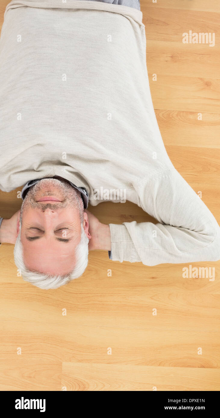 Overhead view of a man sleeping on parquet floor Stock Photo - Alamy