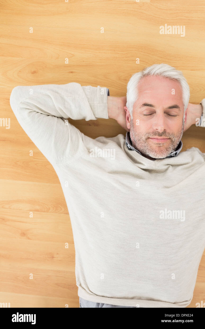 Overhead view of a man sleeping on parquet floor Stock Photo - Alamy