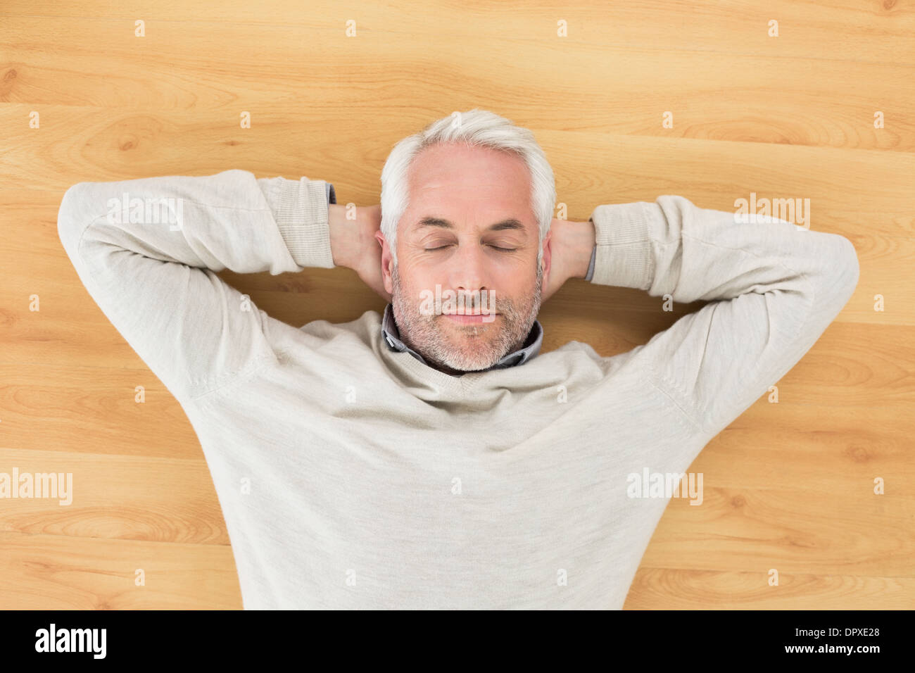Overhead view of a man sleeping on parquet floor Stock Photo - Alamy