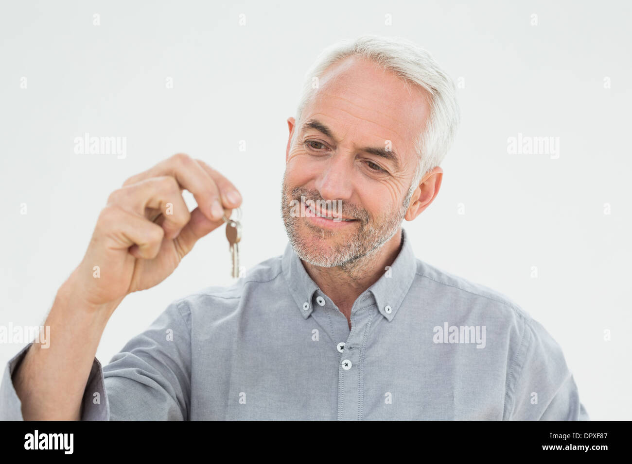 Close-up of a smiling mature man holding house keys Stock Photo - Alamy