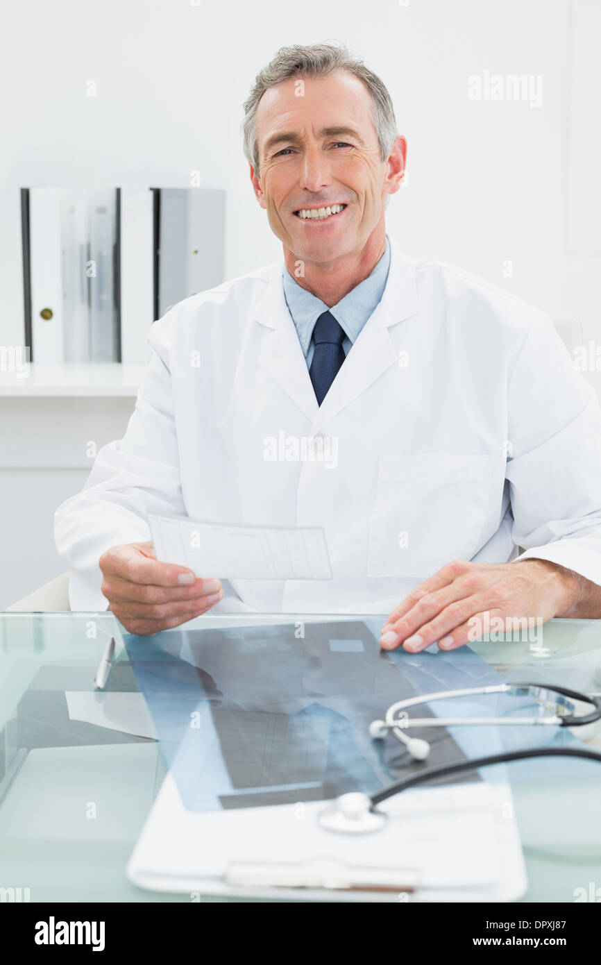 Doctor sitting at desk hi-res stock photography and images - Alamy