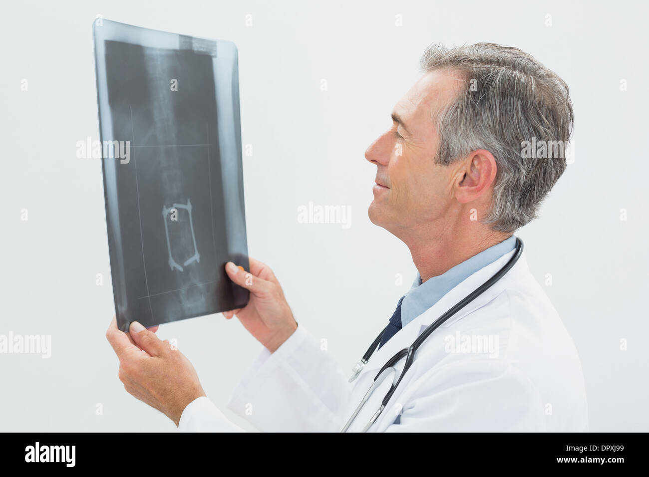 Concentrated male doctor looking at x-ray Stock Photo - Alamy