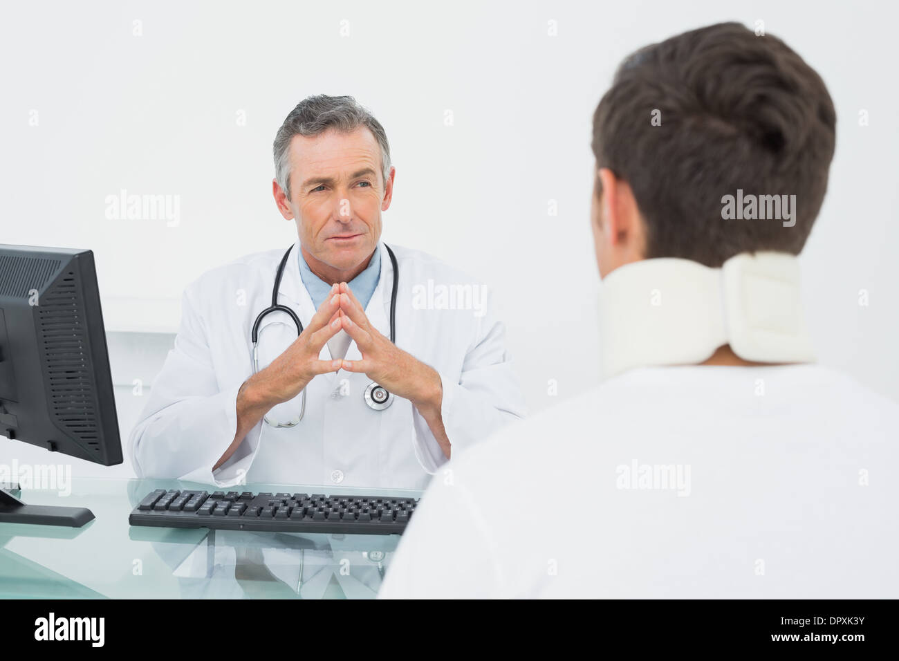 Doctor in conversation with patient in office Stock Photo - Alamy